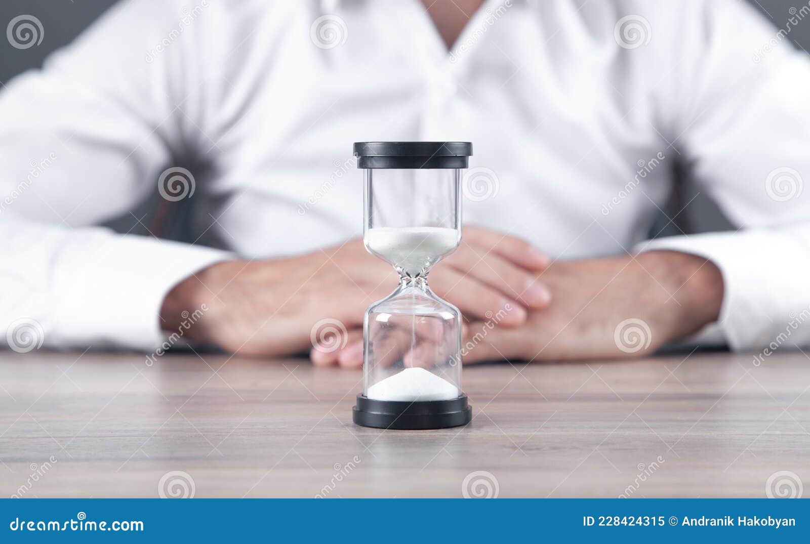 Hourglass on the Desk with a Man Sitting in Office Stock Image - Image ...