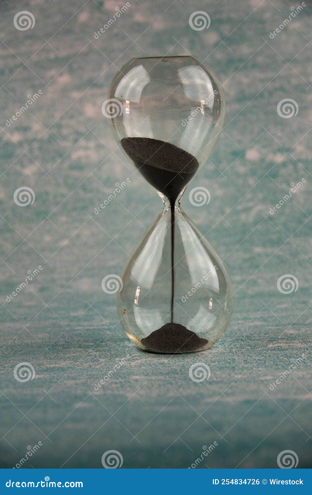 Hourglass with Flowing Sand in a Studio, Vertical Shot Stock Photo ...