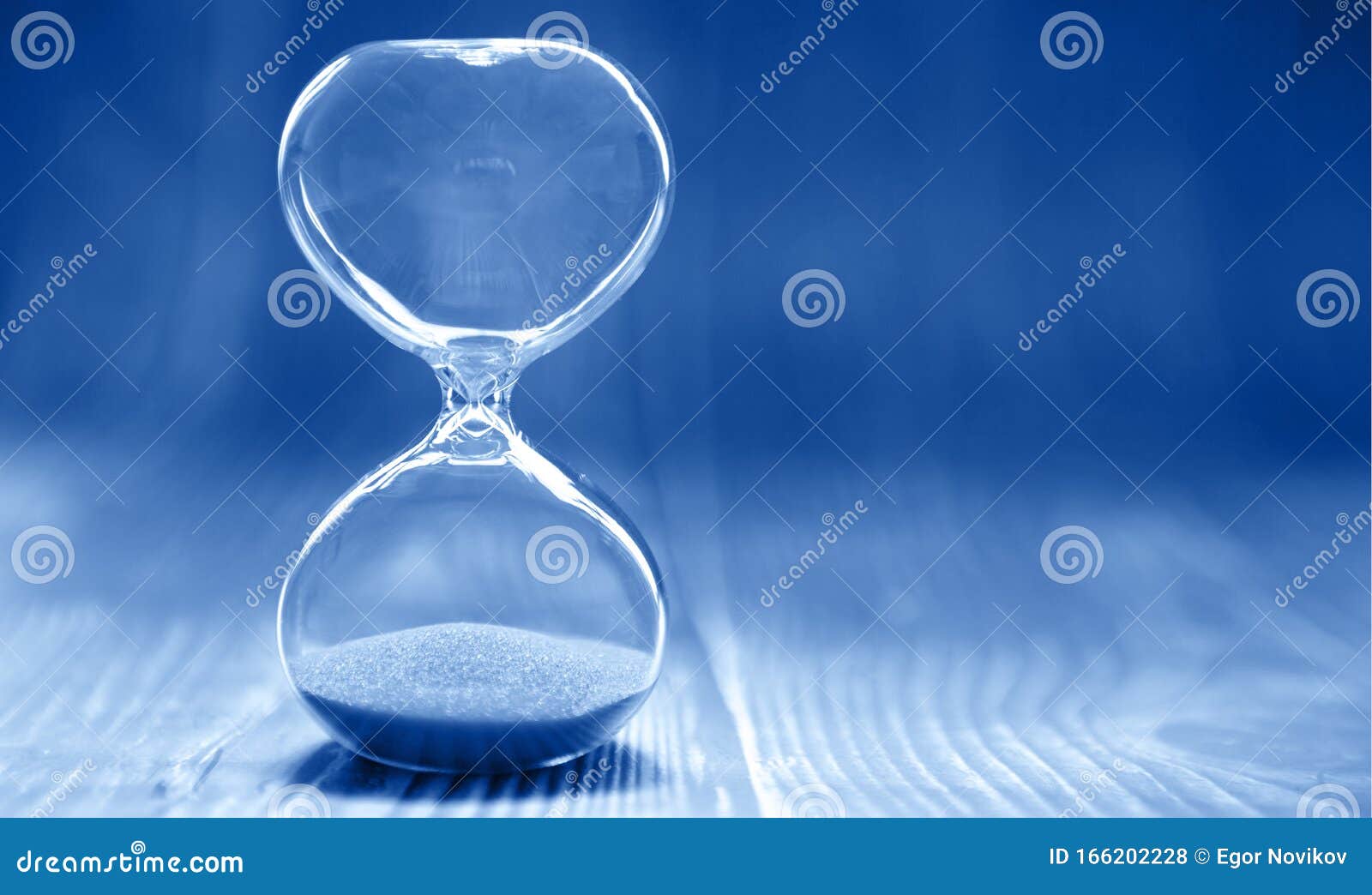 Hourglass on a Modern Trendy Blue Background, Time and Glass Stock ...