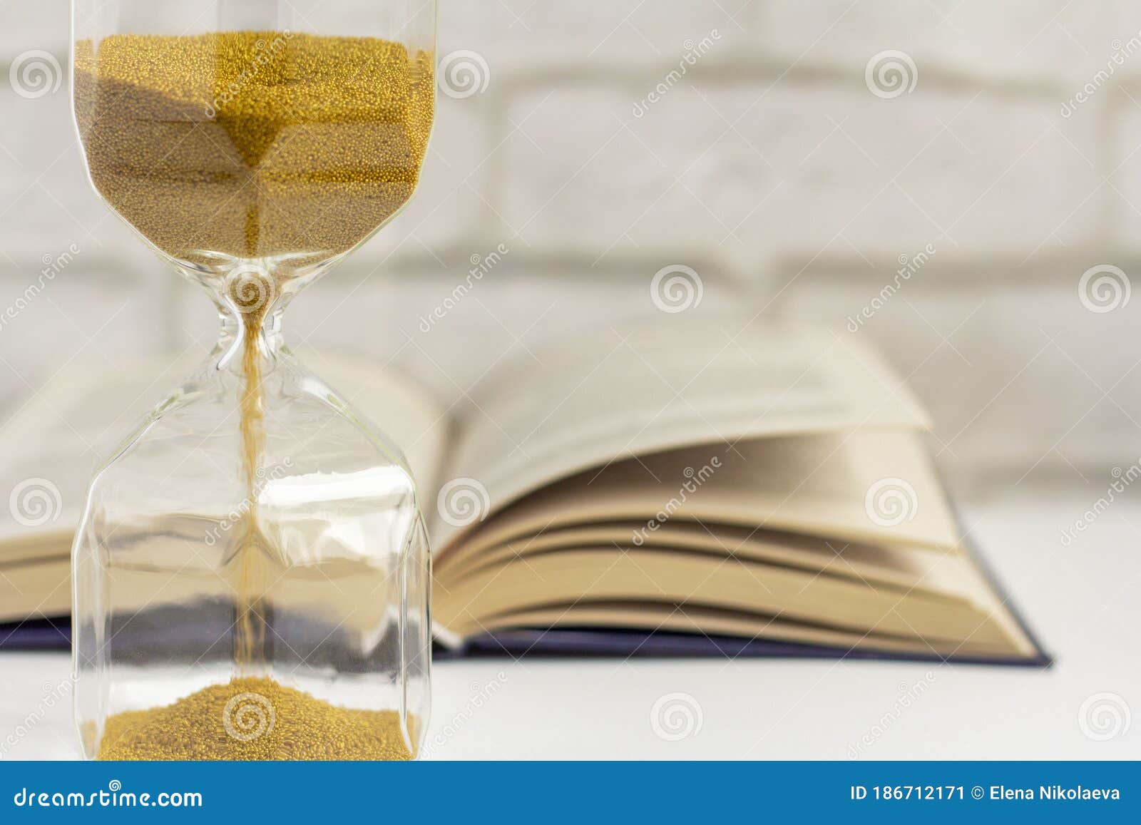 An Hourglass and an Open Book on the Table Stock Image - Image of paper ...