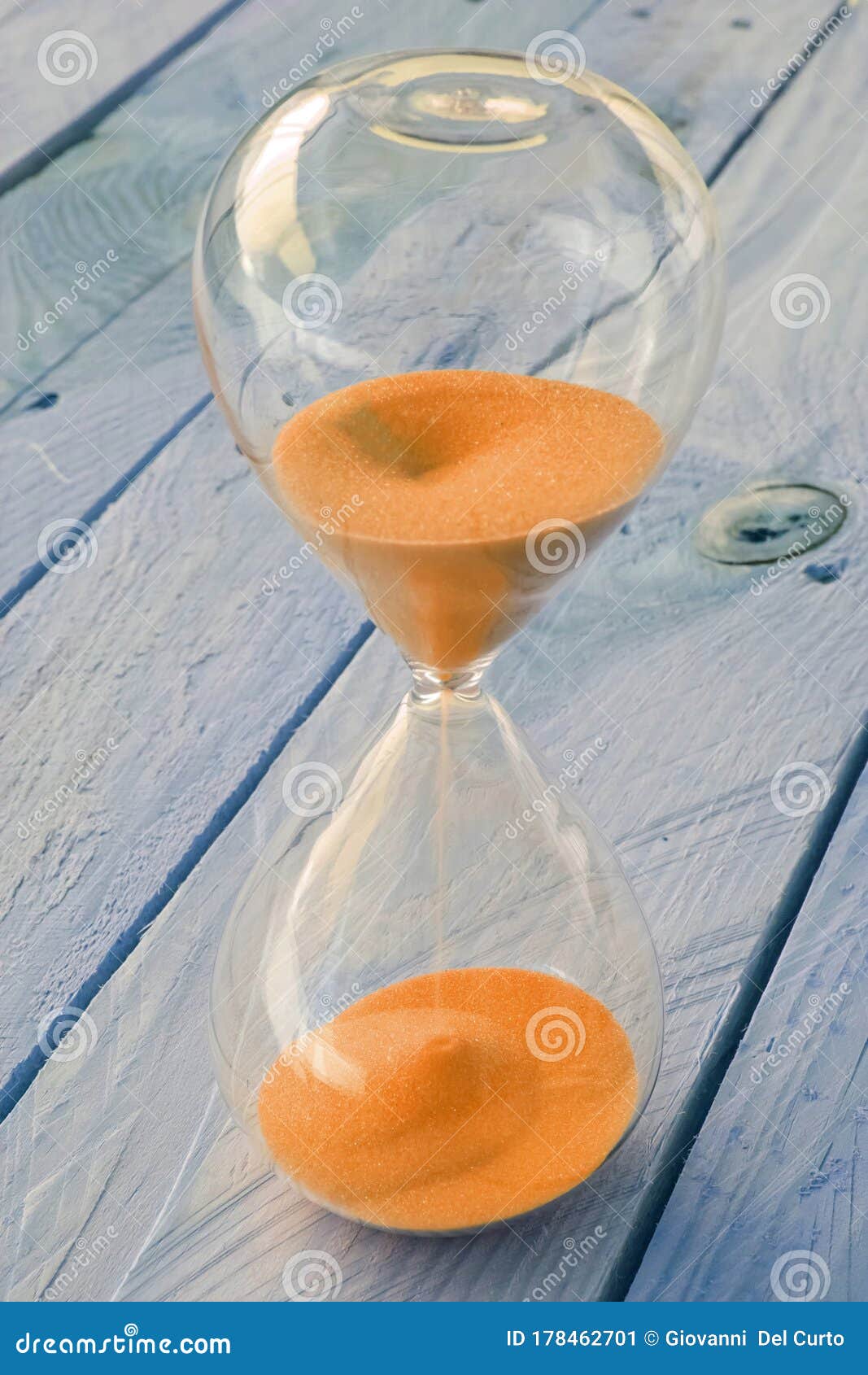 HOURGLASS with ORANGE SAND and WOOD BACKGROUND Stock Image - Image of ...