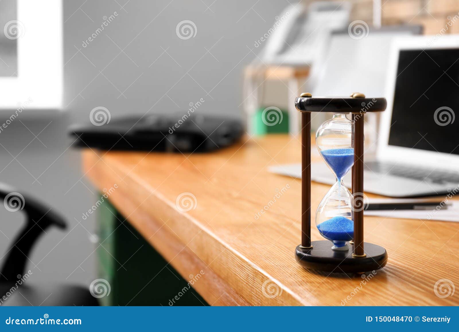 Hourglass on Table in Office. Time Management Concept Stock Photo ...