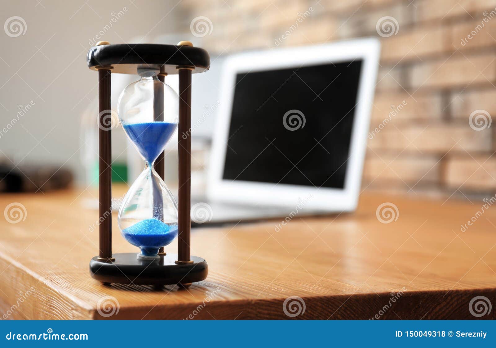 Hourglass on Table in Office. Time Management Concept Stock Photo ...