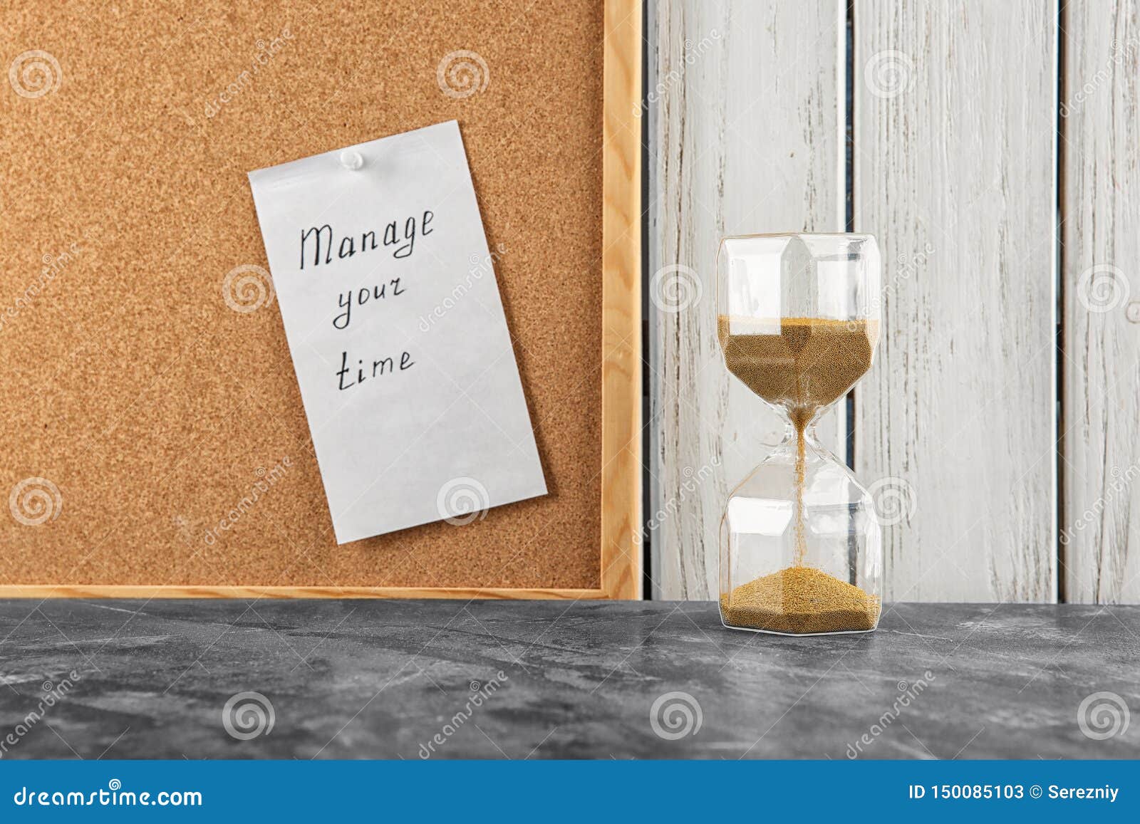 Hourglass on Table and Sheet of Paper with Phrase "Manage Your Time ...
