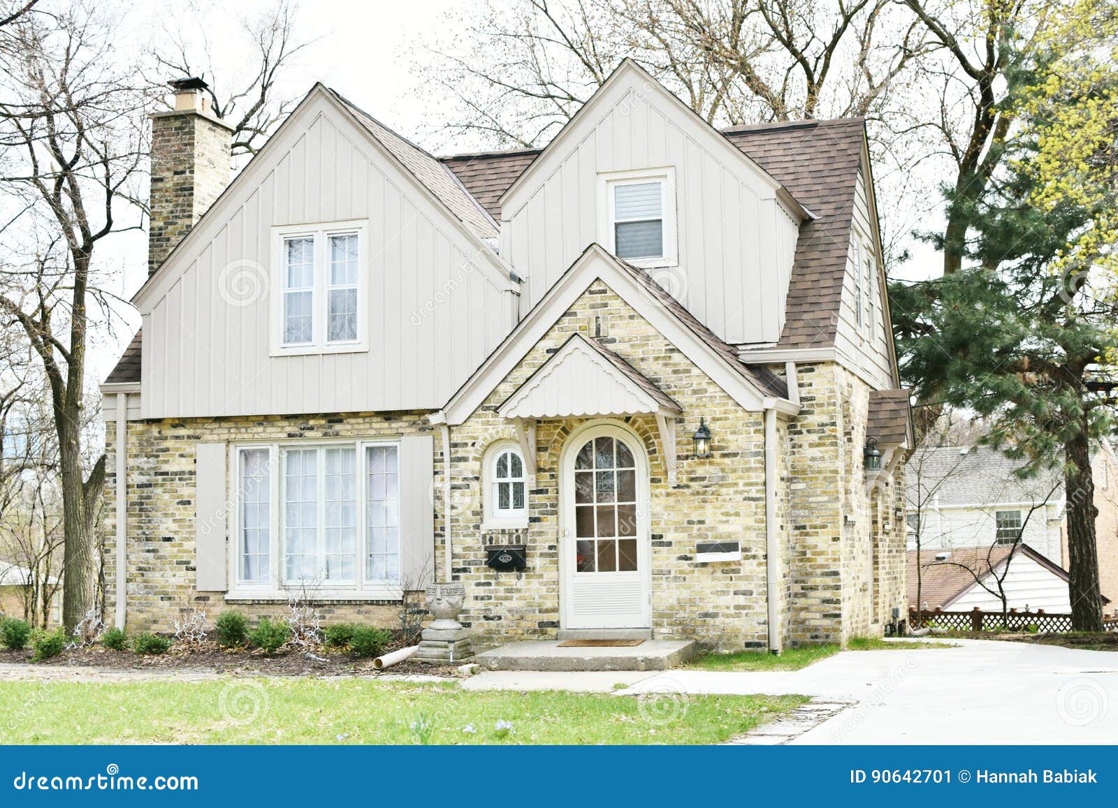 Cute Brick And Rock Cottage With Gabled Entrance And Arched Door With ...