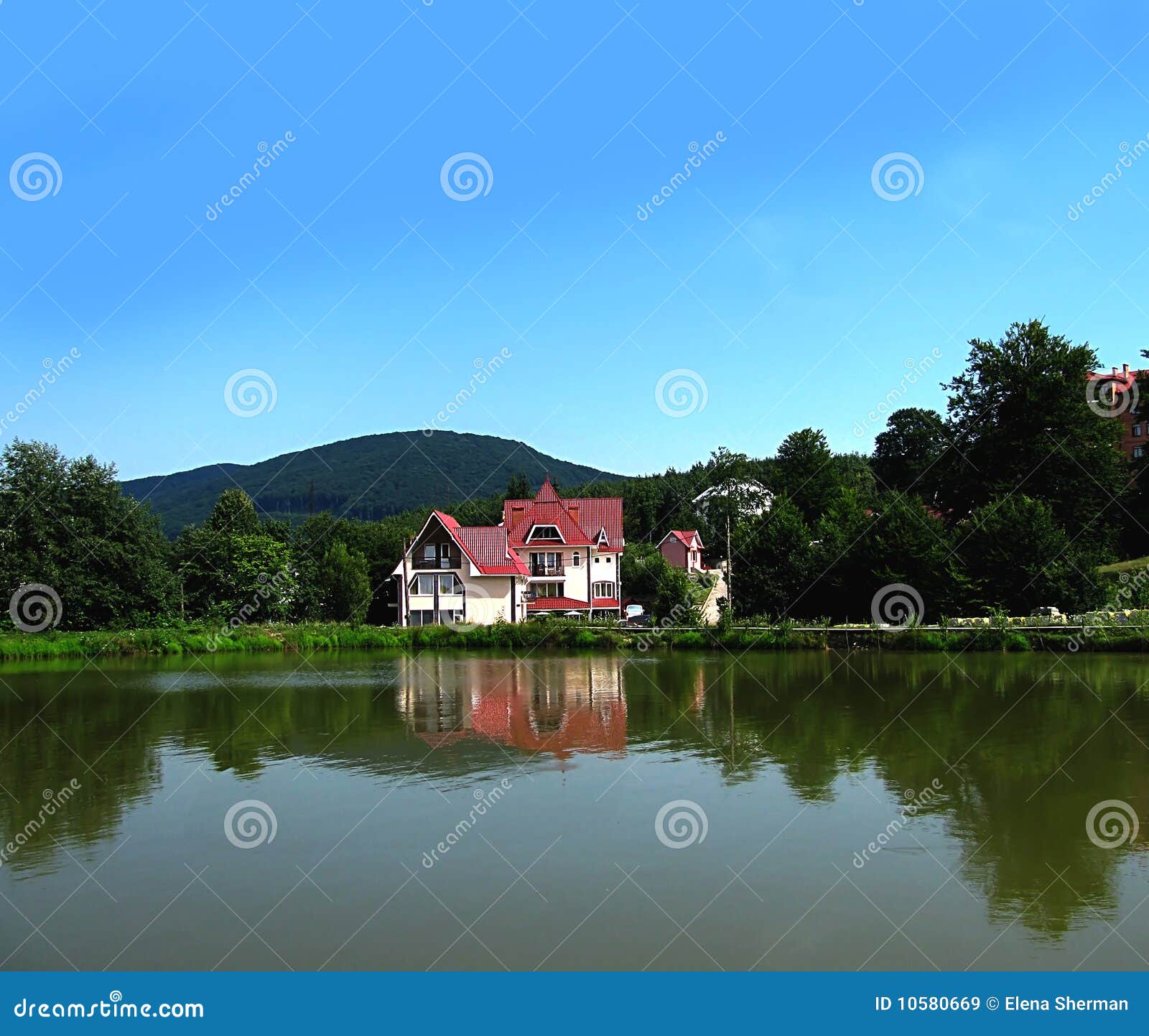 House on the bank of lake stock image. Image of mountain - 10580669