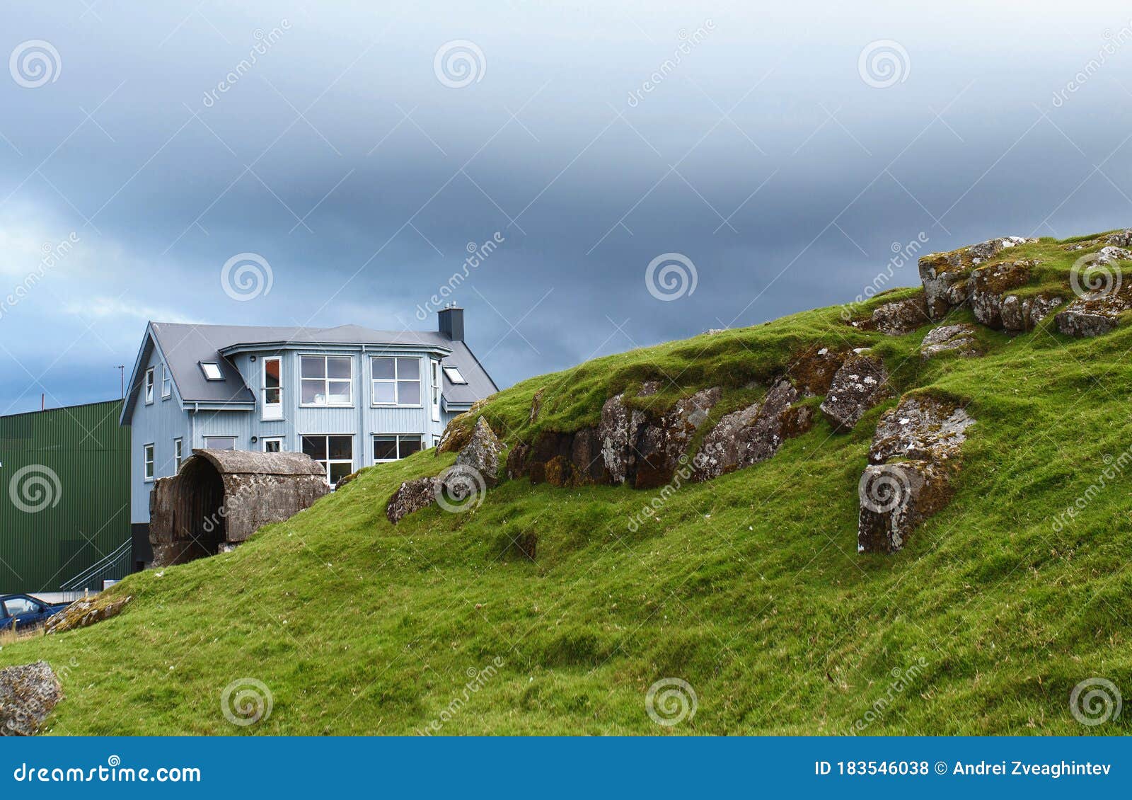 House behind green hill stock photo. Image of landscape - 183546038