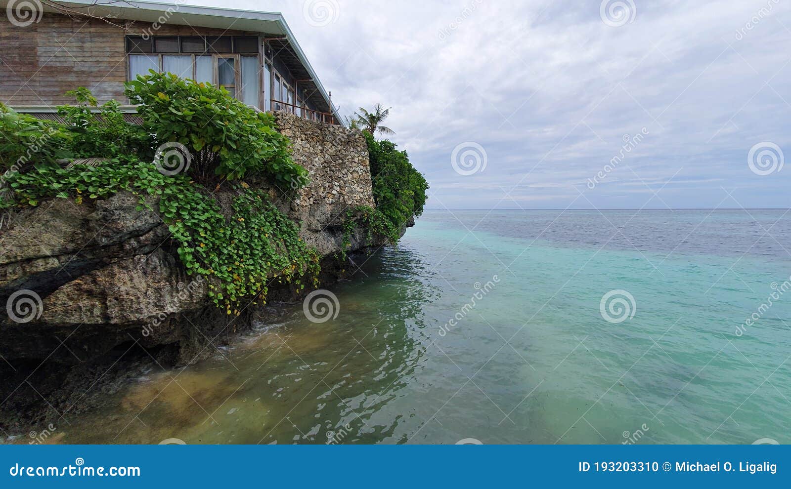 House Built Atop Rock by the Sea Stock Photo - Image of tree, rock ...