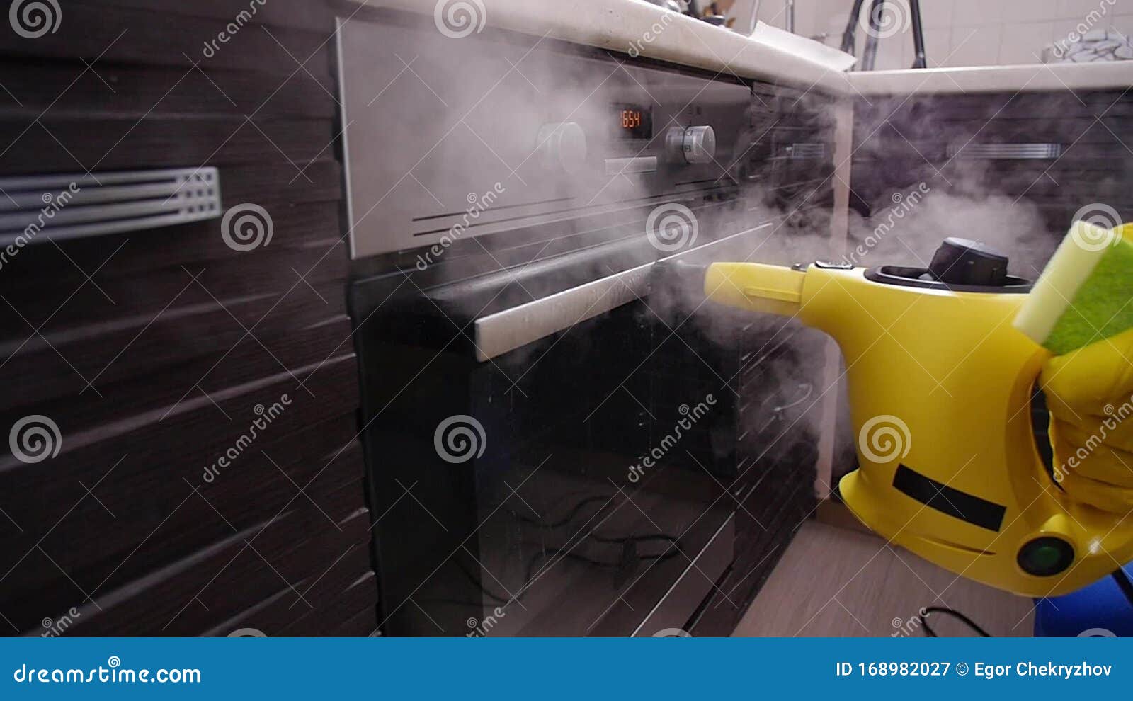 House Cleaning Concept. Man Cleaning Kitchen with Steam Cleaner Stock ...