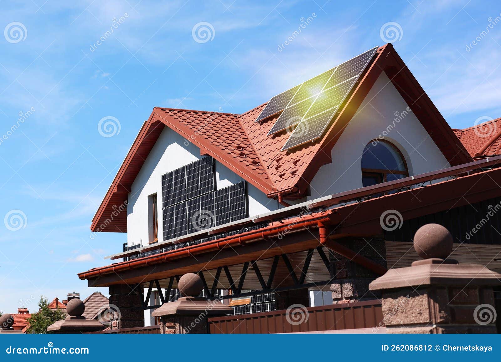 House with Installed Solar Panels Under Blue Sky. Alternative Energy ...