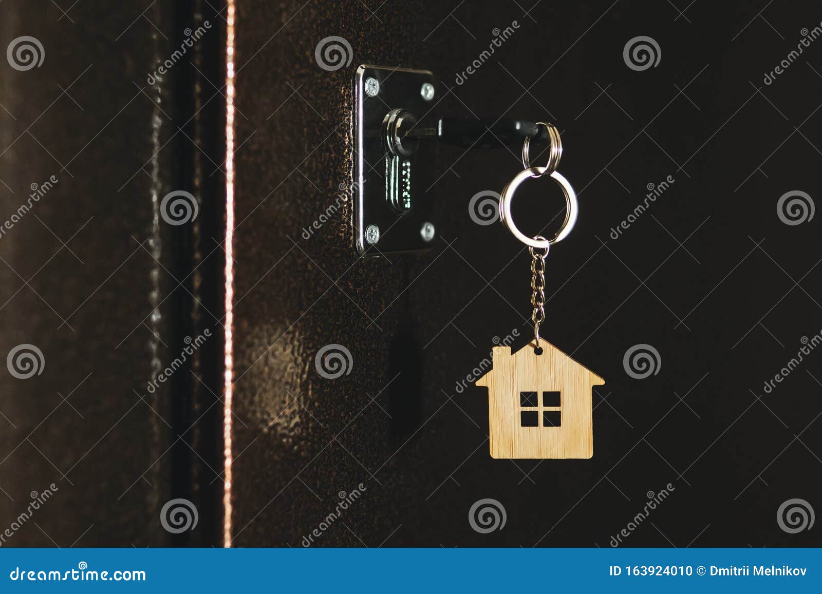 House Key with House Model Keychain in Door. Process of Opening the ...