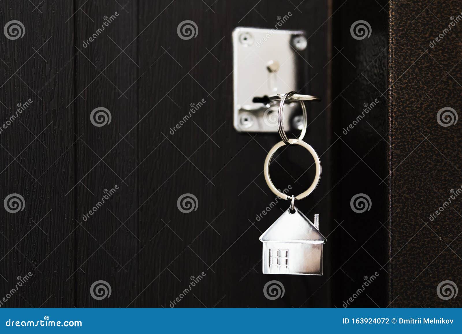 House Key with House Model Keychain in Door. Process of Opening the ...