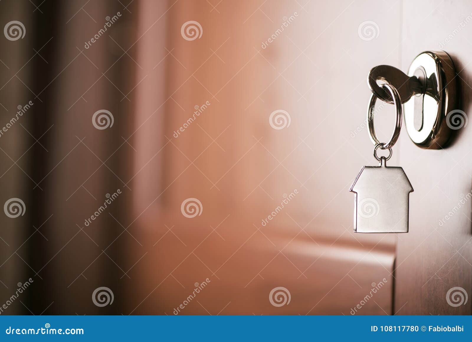 House Key on a House Shaped Silver Keyring in the Lock of a Entrance ...