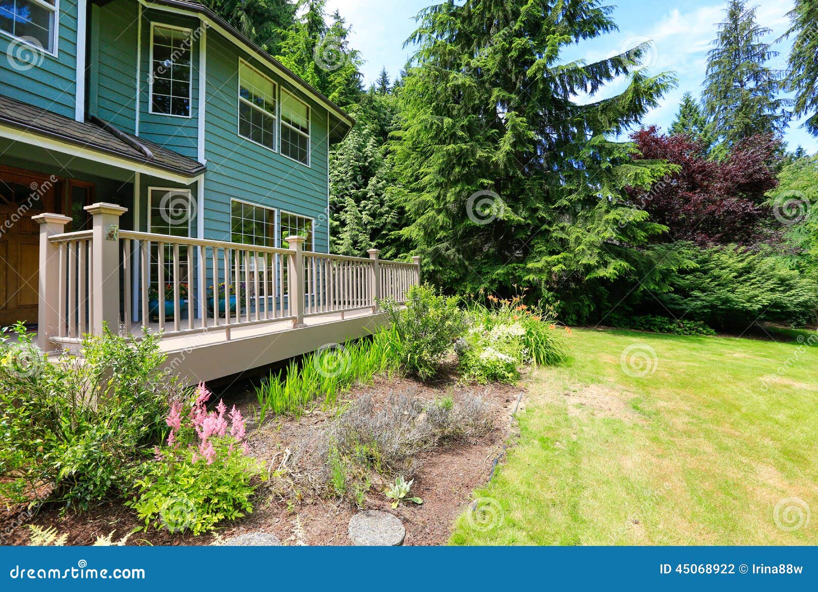 House with Large Walkout Deck Overlooking Backyard Landscape Stock ...