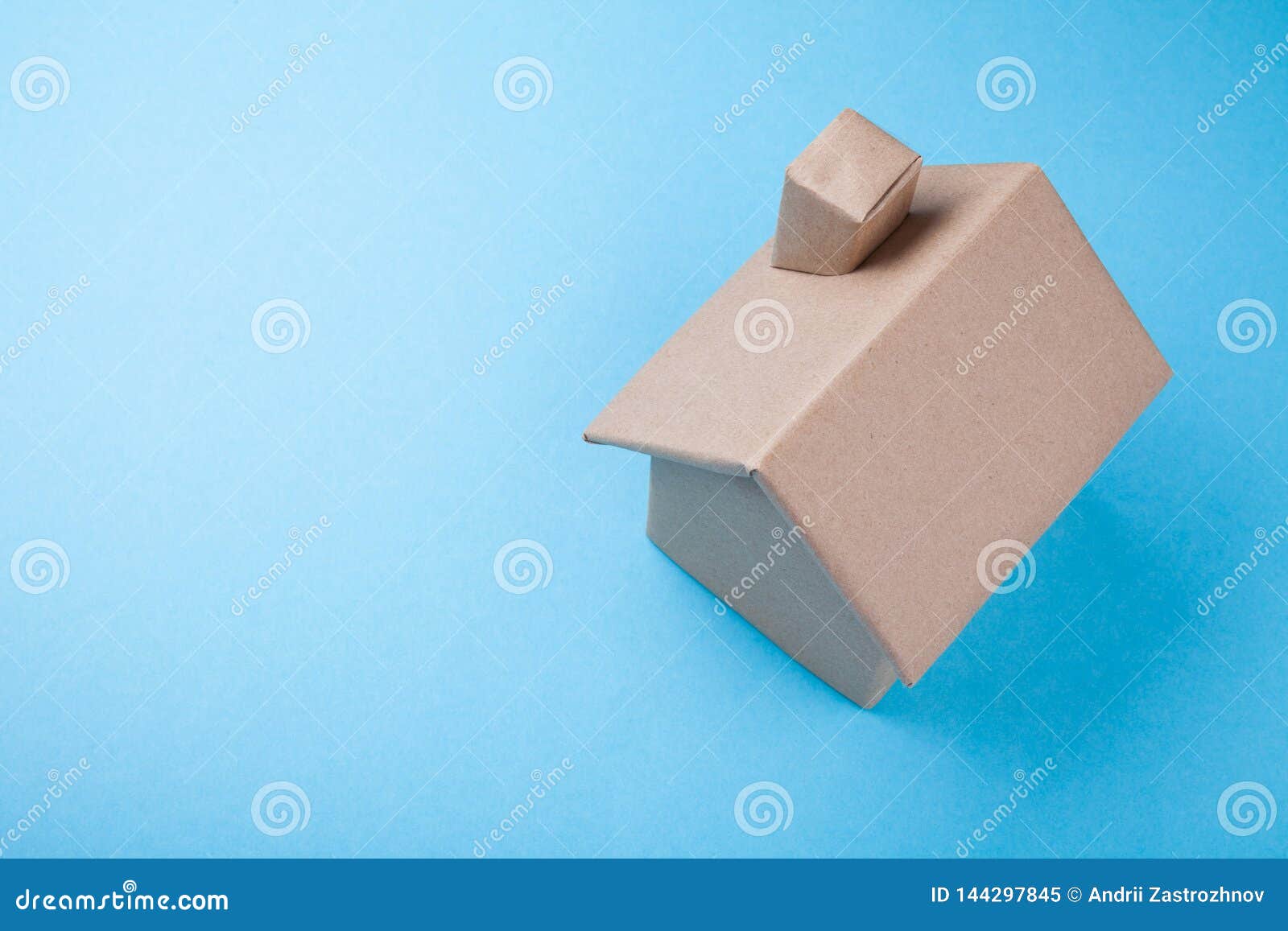 A House Project Made of Cardboard on a Blue Background Stock Image ...