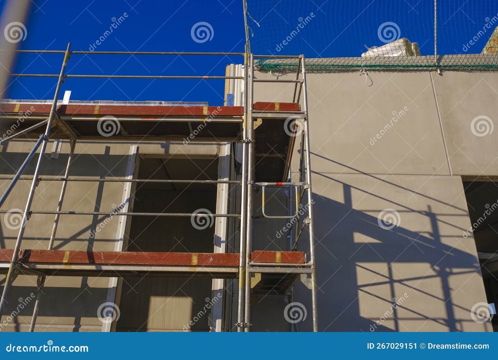 House in Scaffolding on Blue Sky Background.walls of the House in ...