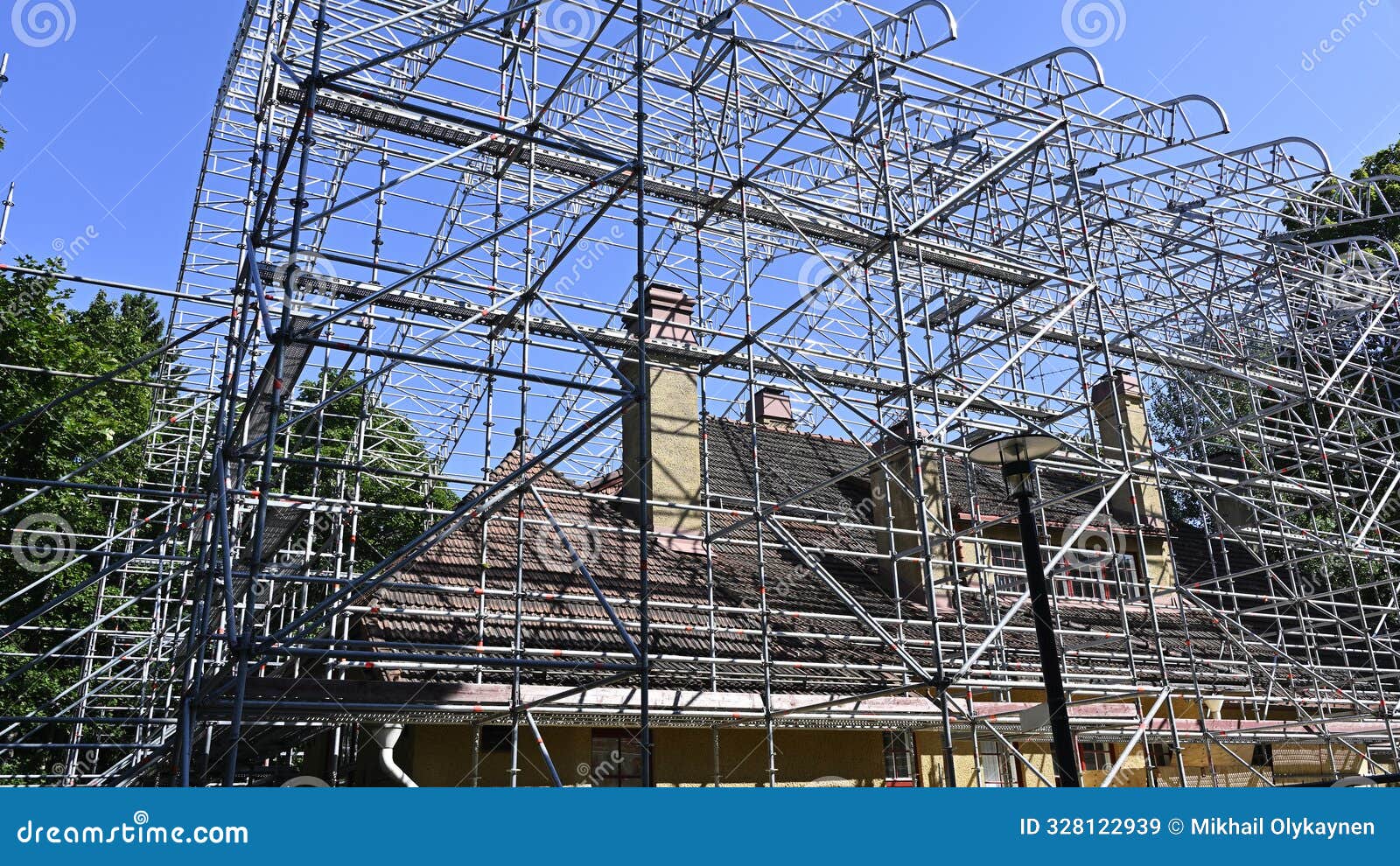 A House Undergoing Renovation Is Surrounded By An Extensive Scaffolding ...