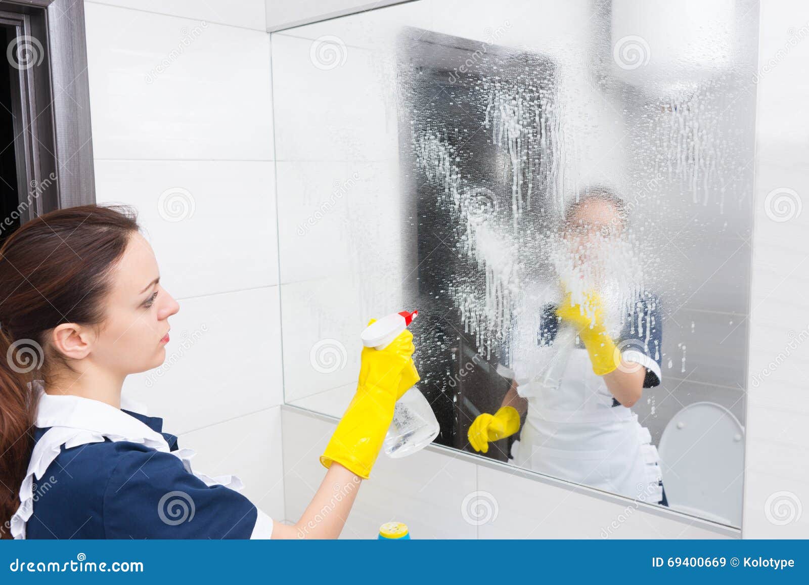Housekeeper Cleaning a Wall Mirror Stock Image - Image of reflection ...