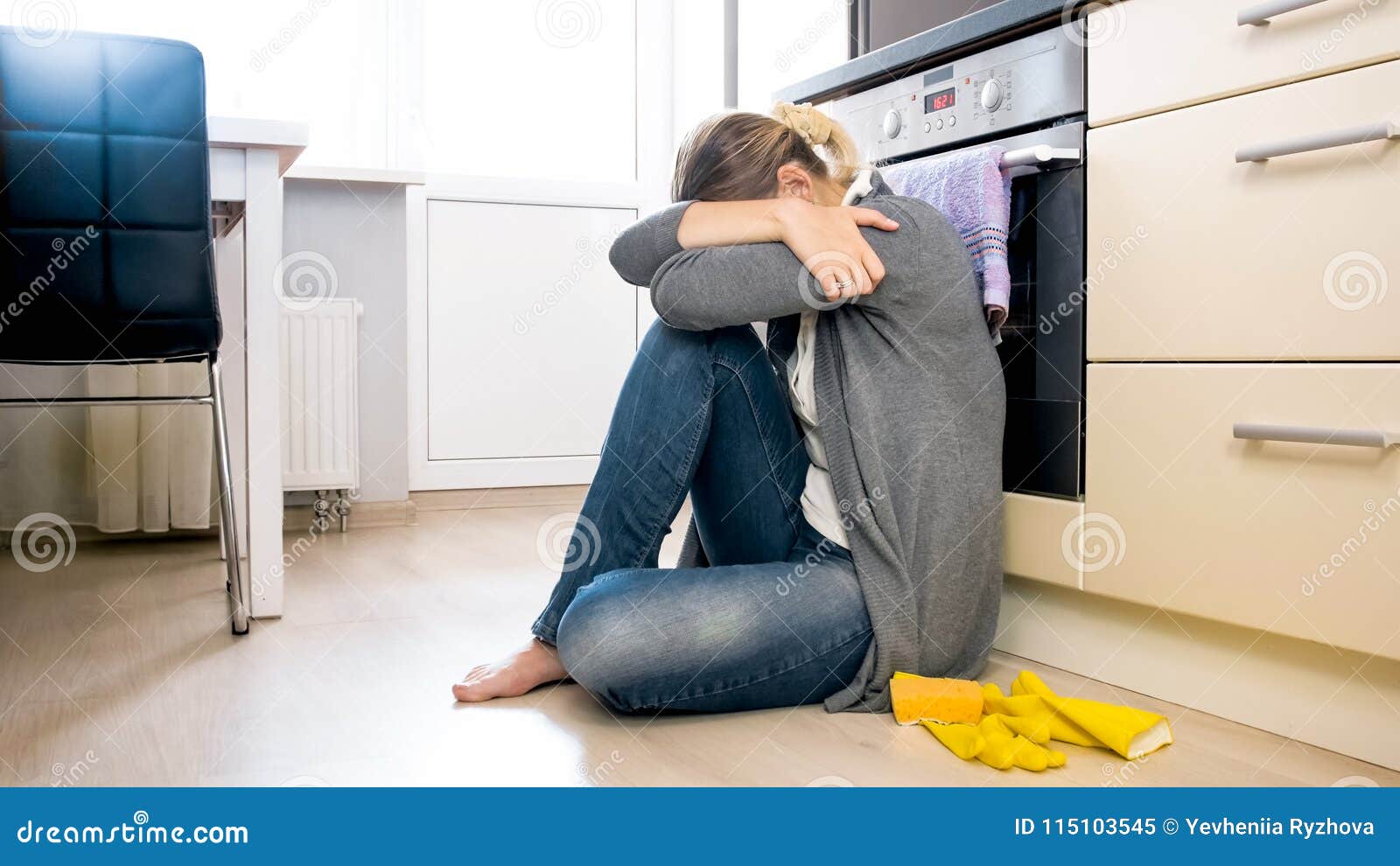 Young Housewife in Depression Sitting on Floor at Kitchen Stock Image ...