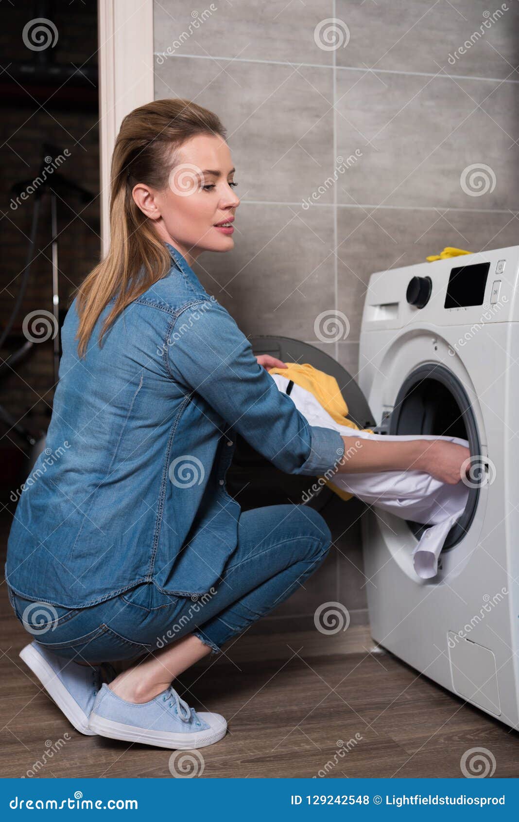Housewife Taking Out Laundry from Washing Machine Stock Photo - Image ...