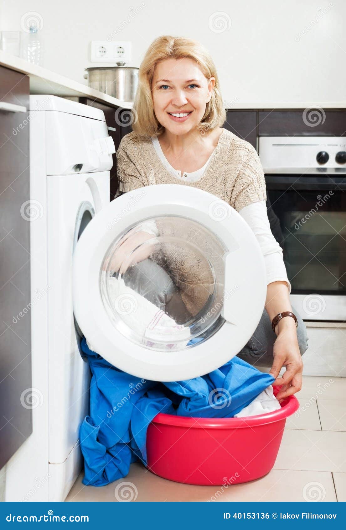 Housewife Using Washing Machine at Home Stock Photo - Image of smiling ...