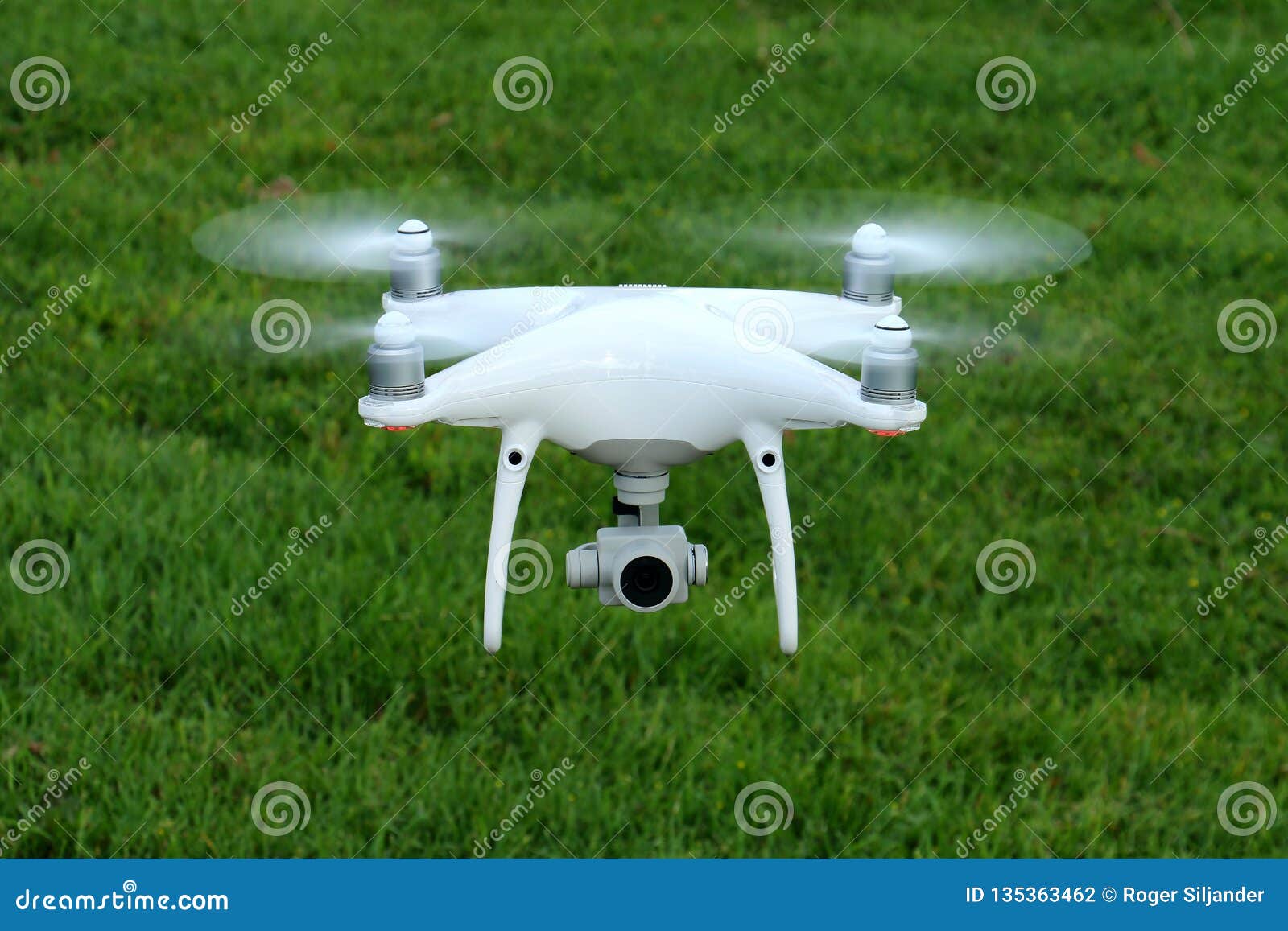 Hovering Drone with Grass Background Stock Photo - Image of technology ...