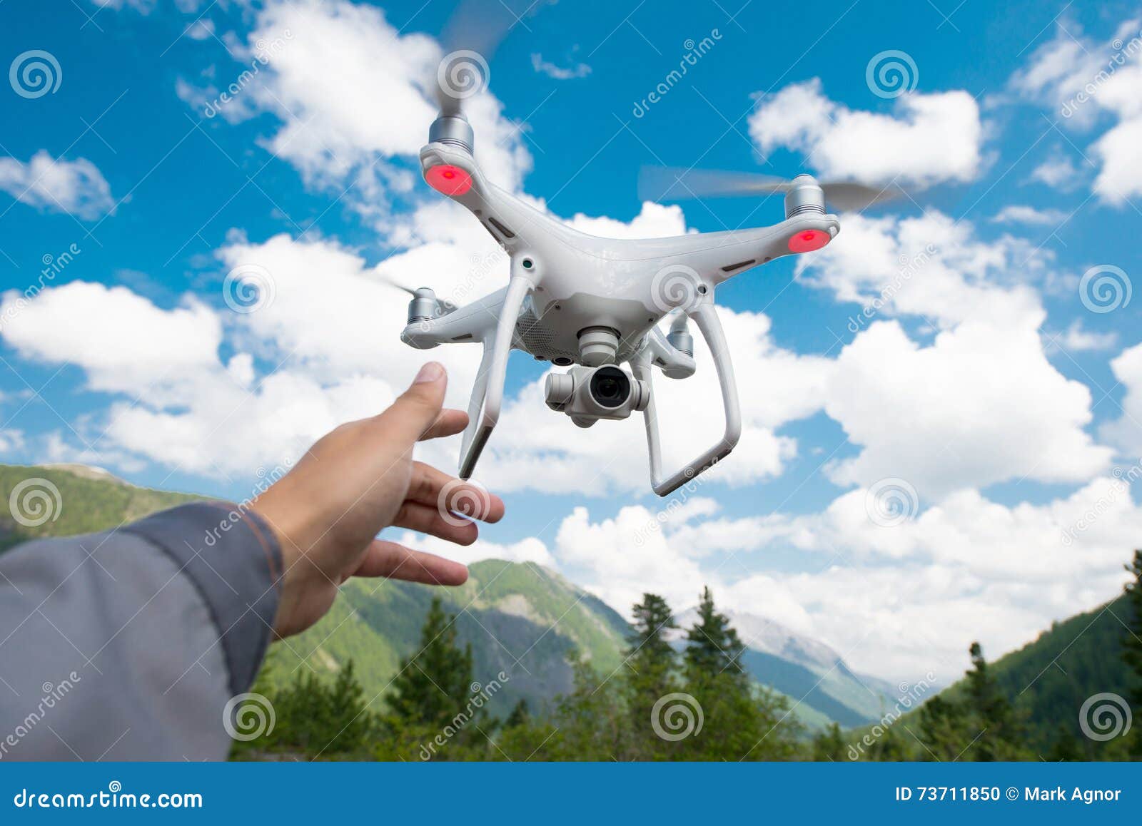 Hovering drone and a hand stock photo. Image of flight - 73711850