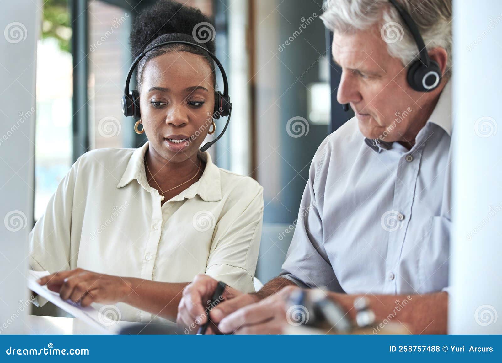 How Do I Sort this Out. Two Call Centre Agents Sitting Together in the ...
