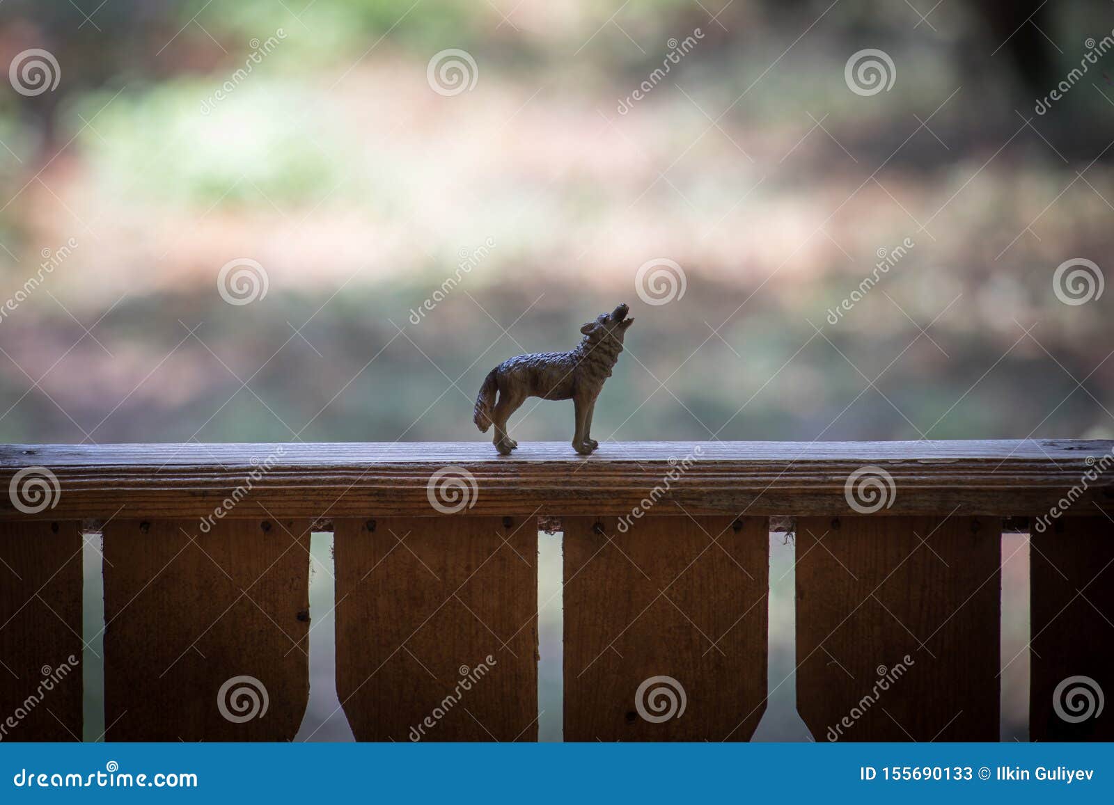 Howling Wolf in the Forest. Mini Wolf Figure Standing on the Forest ...