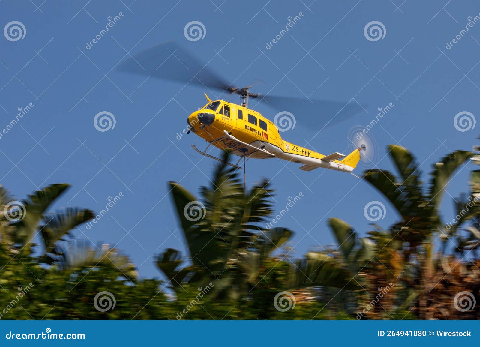 Huey Firefighting Helicopter Over Green Trees Editorial Image - Image ...