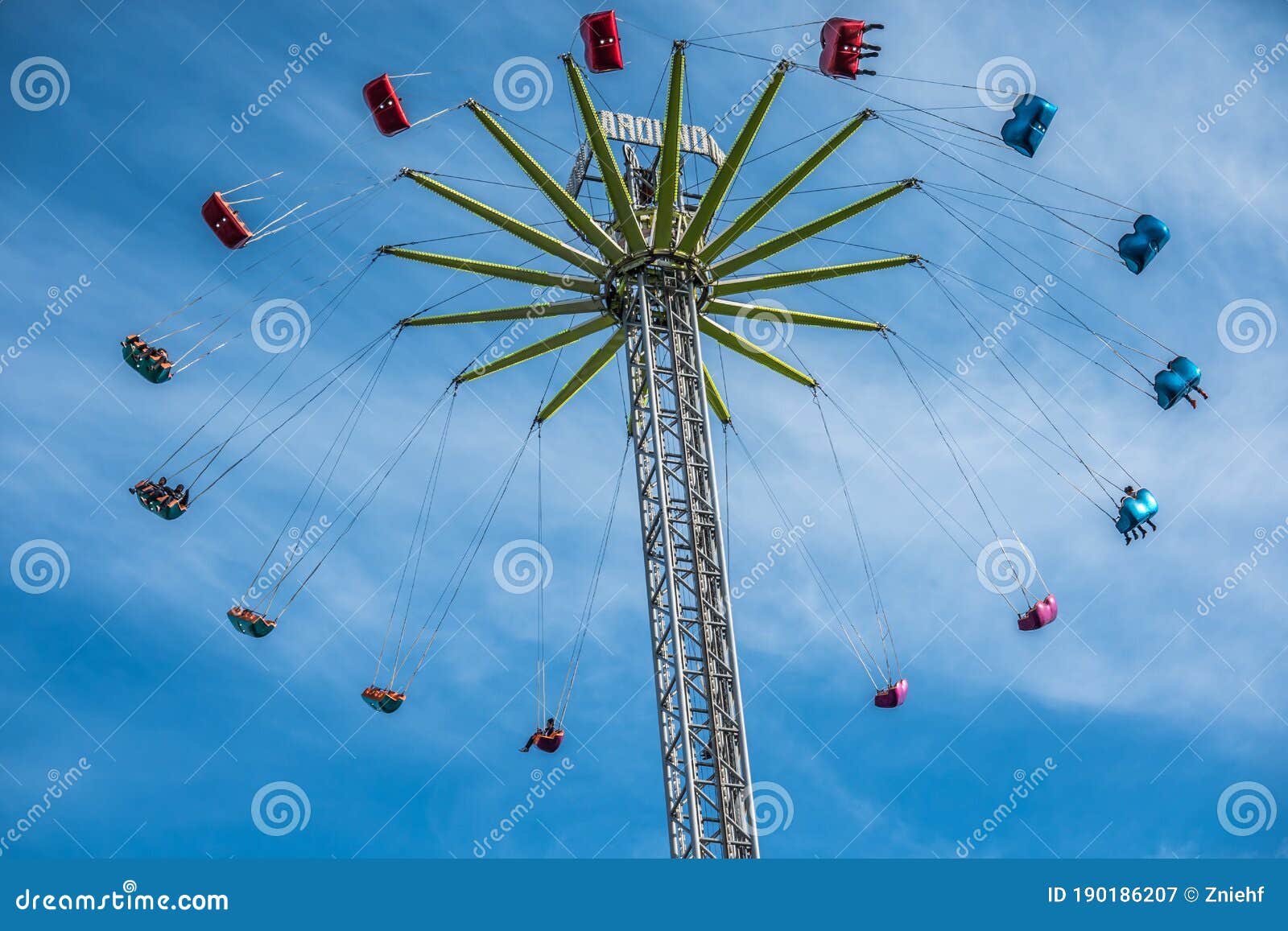Huge Chain Carousel with Gondolas in Front of a Bright Blue Sky ...