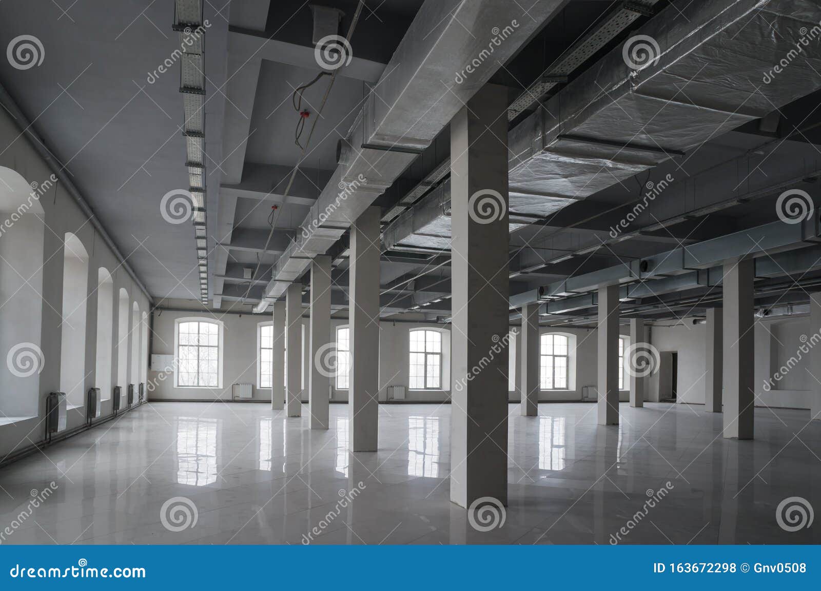 Huge Empty Open Space In The Old Factory Building With Rows Of Columns ...