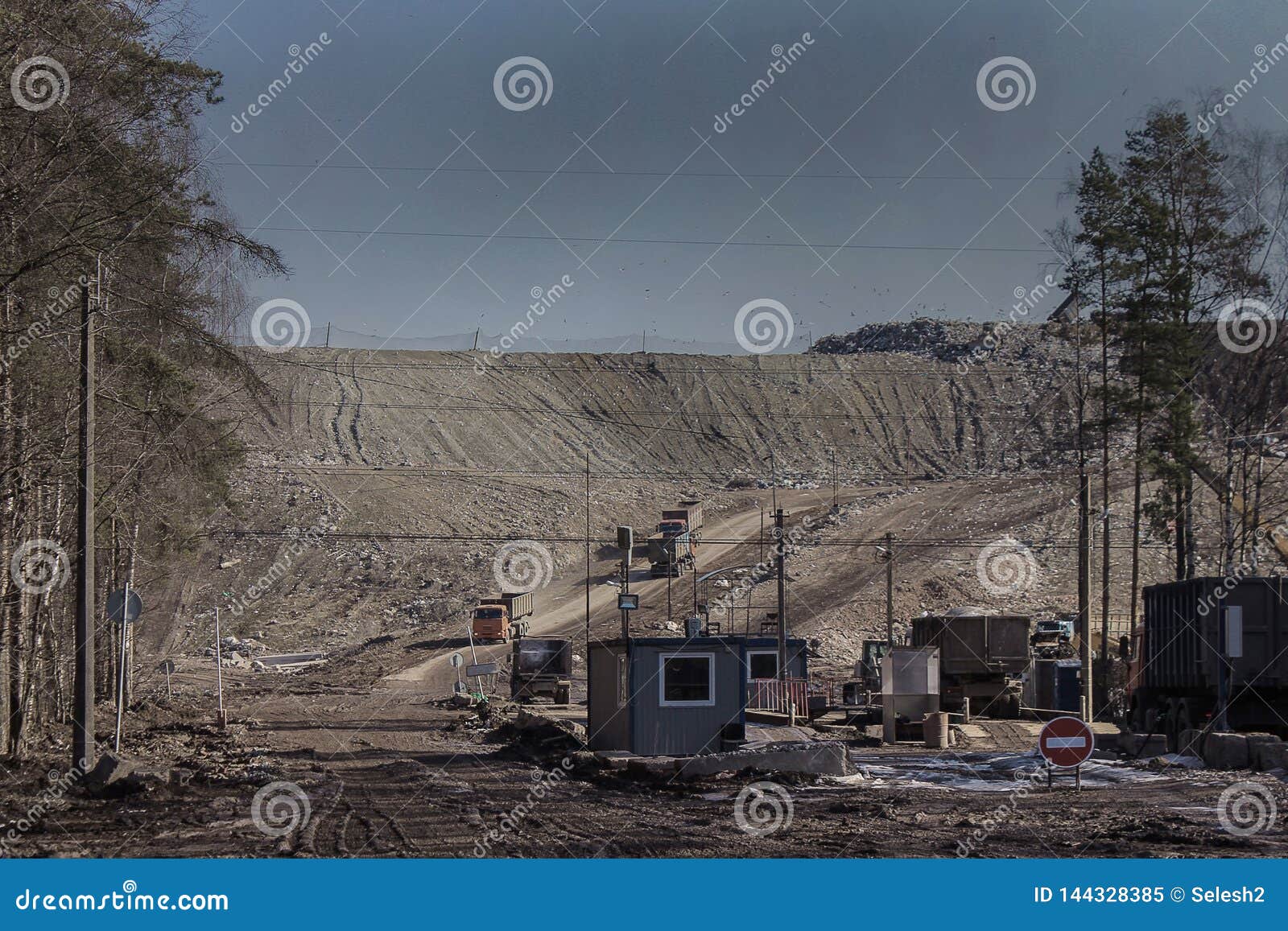 A Huge Garbage Dump.Unloading Garbage Trucks At The Dump Stock Photo ...