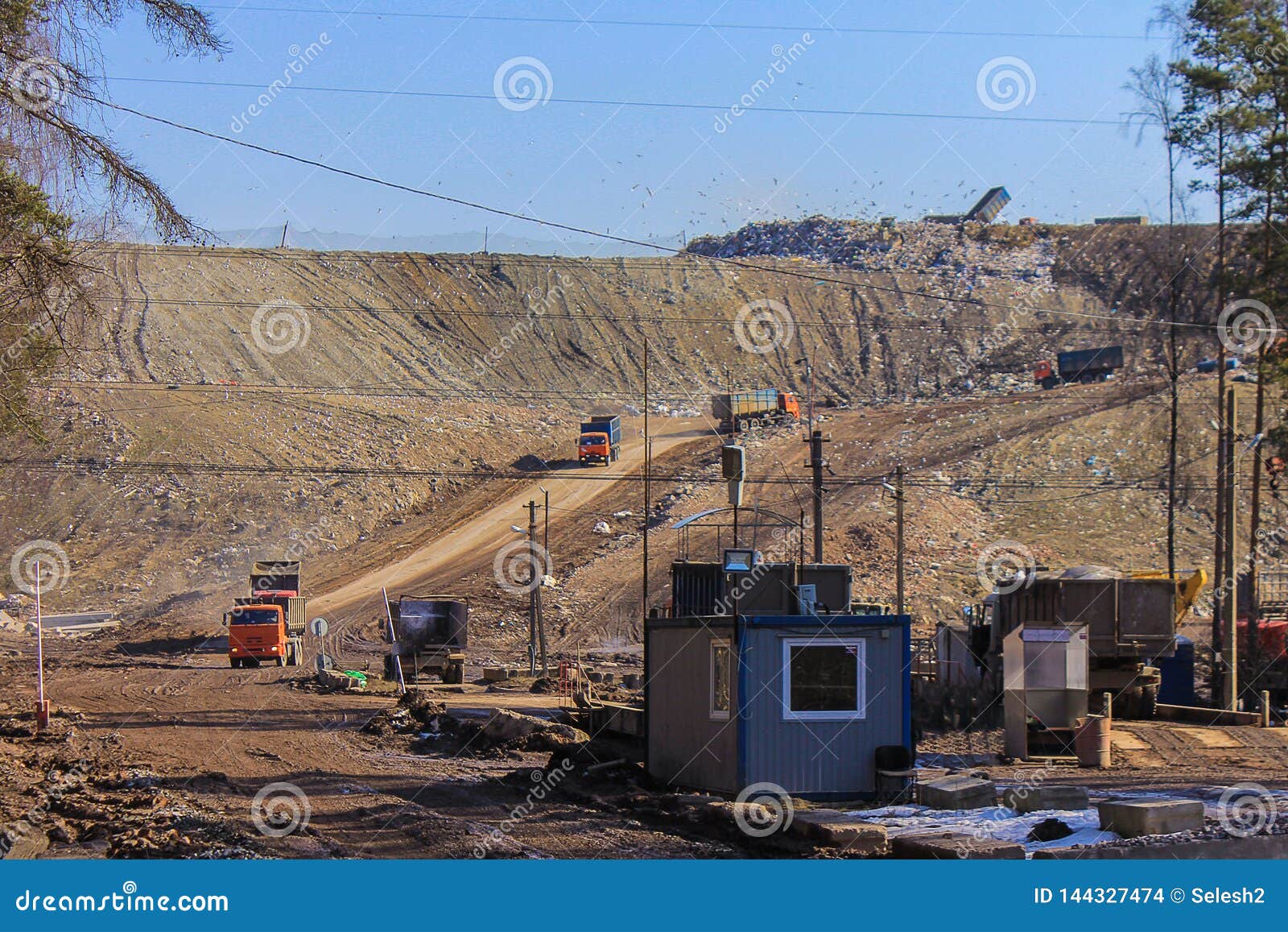 A Huge Garbage Dump.Unloading Garbage Trucks at the Dump Stock Photo ...