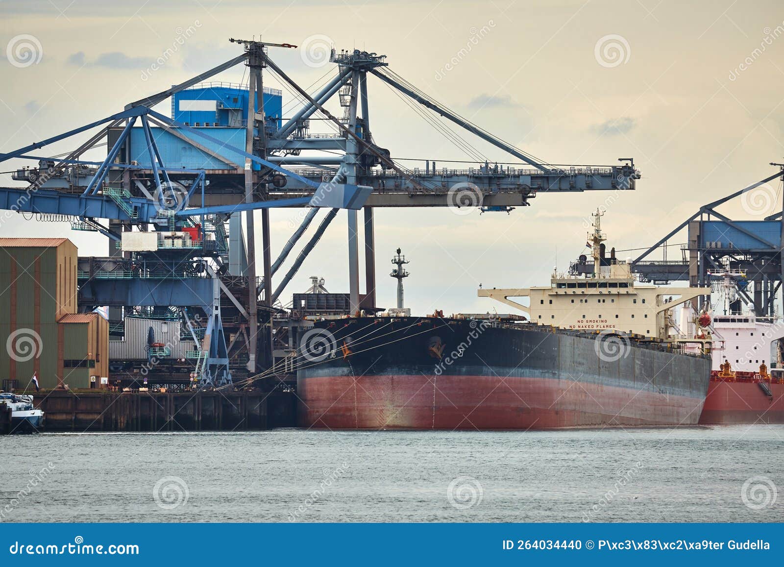 Unloading a huge ship stock photo. Image of shipping - 264034440