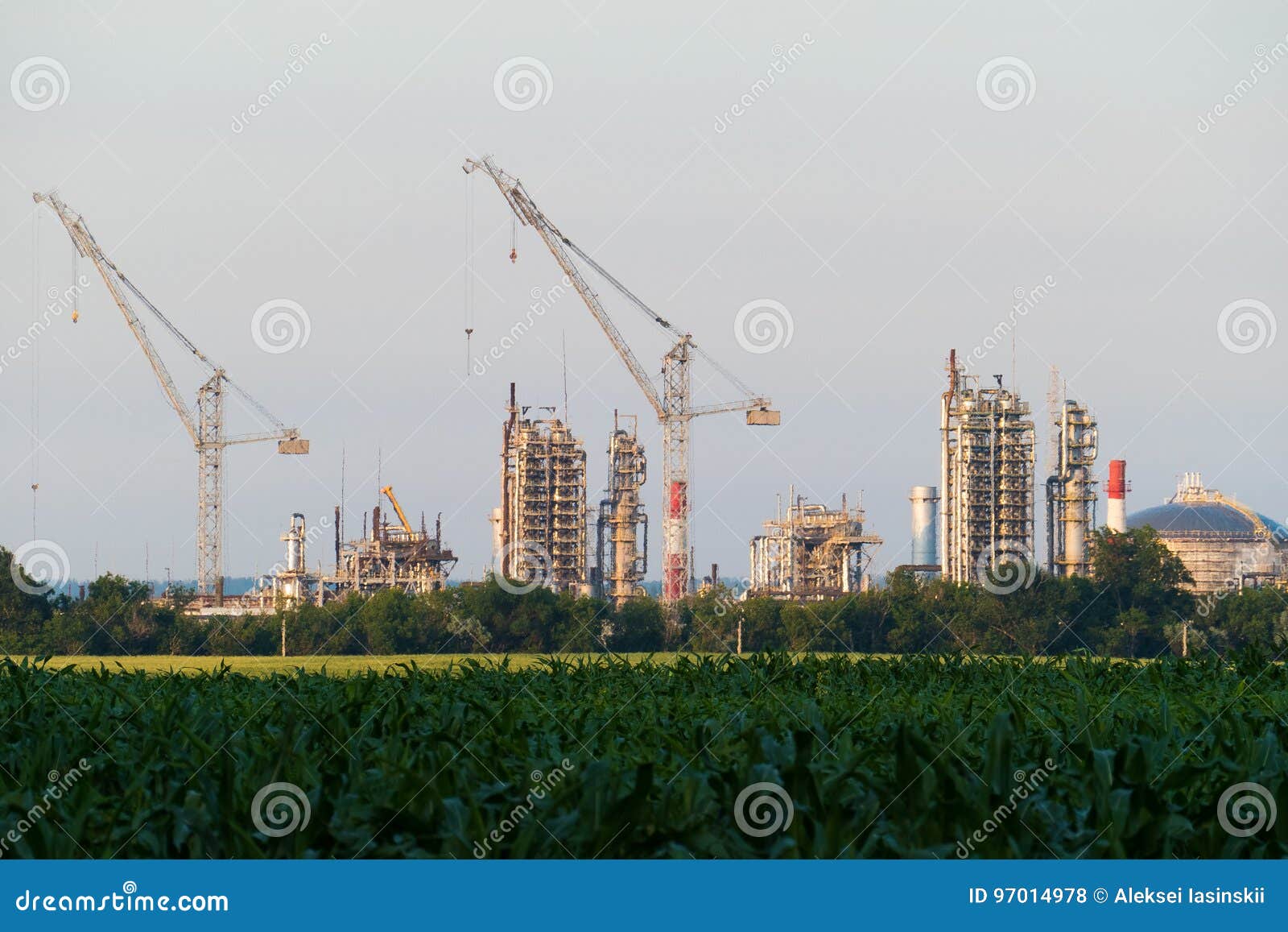 A Huge Oil Refinery with Cranes Under Construction Stock Photo - Image ...