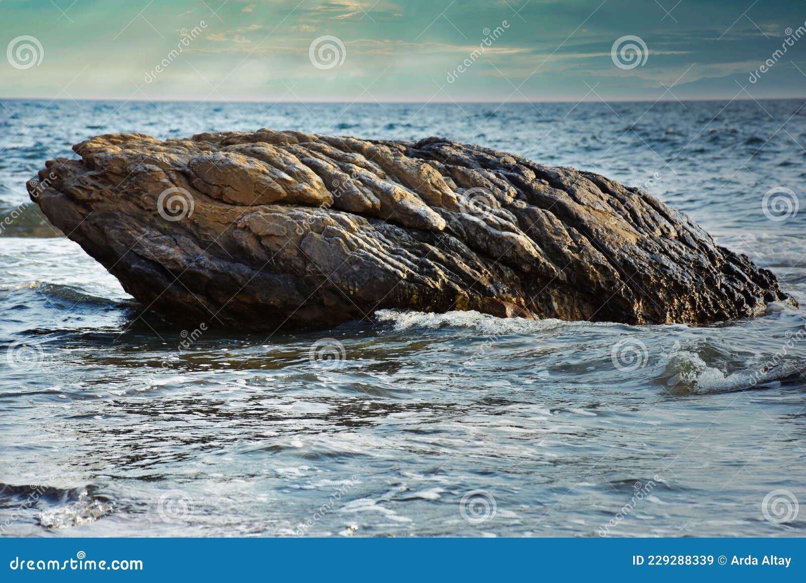 A Huge Rock in the Sea with Stormy Clouds Stock Image - Image of ocean ...