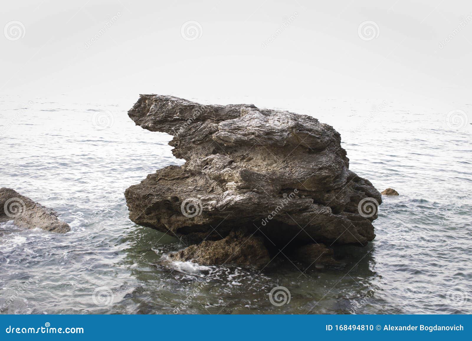 A Huge Rock in the Sea Water. Stone on the Seashore Stock Photo - Image ...