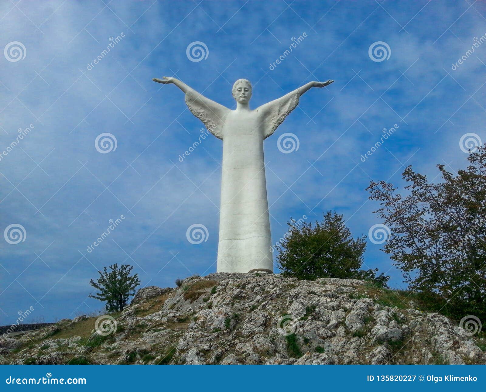 A Huge Snow-white Statue of Christ on the Top of a Mountain Against a ... A Huge Snow-white Statue of Christ on the Top of a Mountain Against a ...