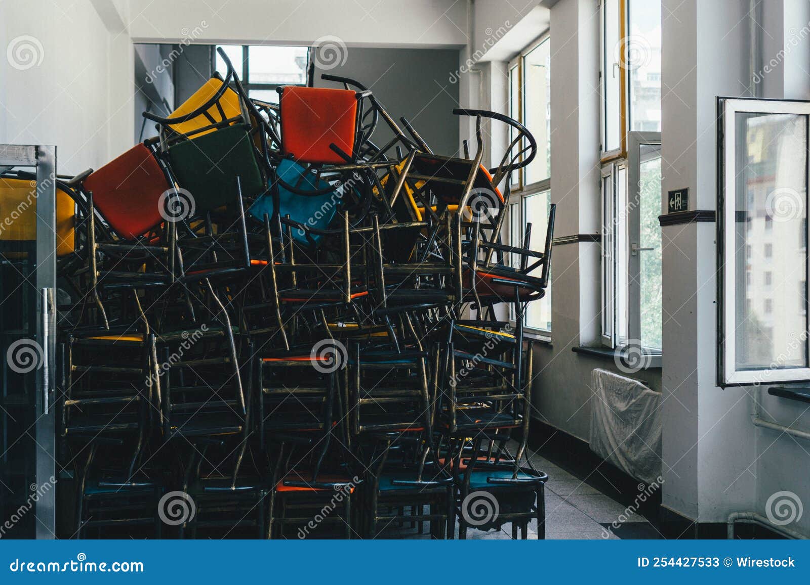 Huge Stack of Colorful Chairs in School Corridor Stock Image - Image of ...