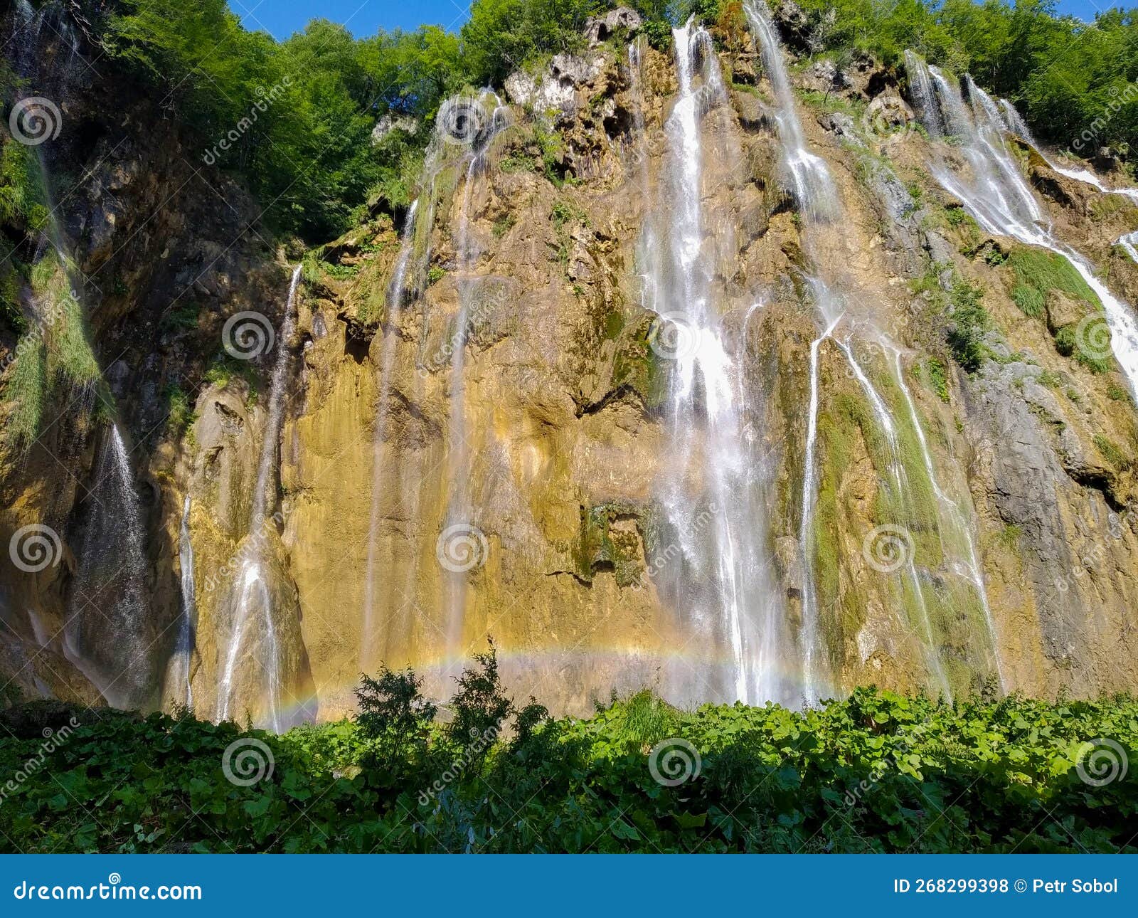 Huge Waterfall Over the Lake with a Rainbow Stock Photo - Image of ...