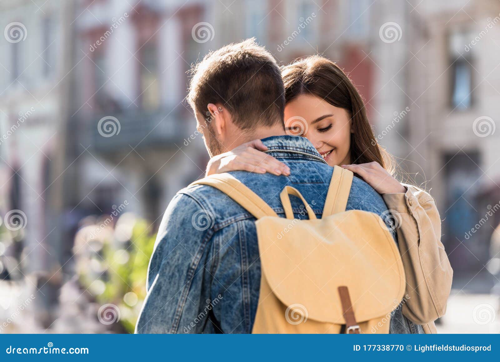 Hugging Boyfriend with Beige Backpack in Stock Photo - Image of ...