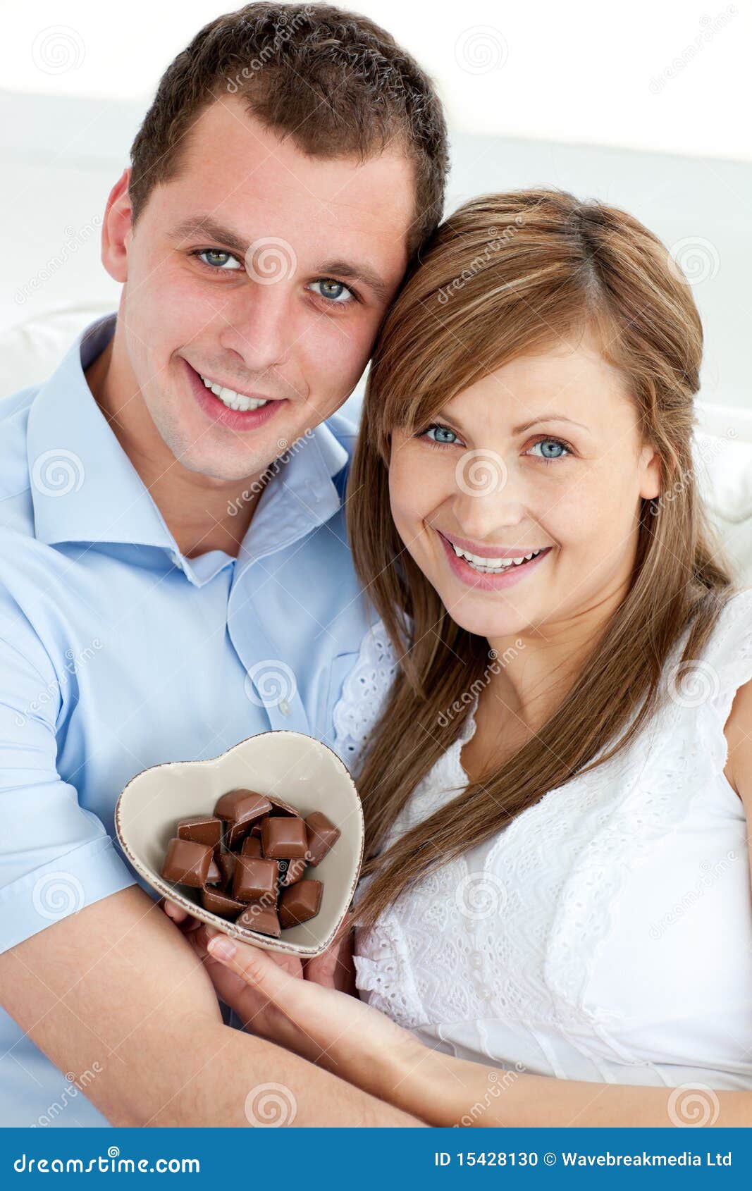 Hugging Couple Holding Chocolate and Smiling Stock Photo - Image of ...