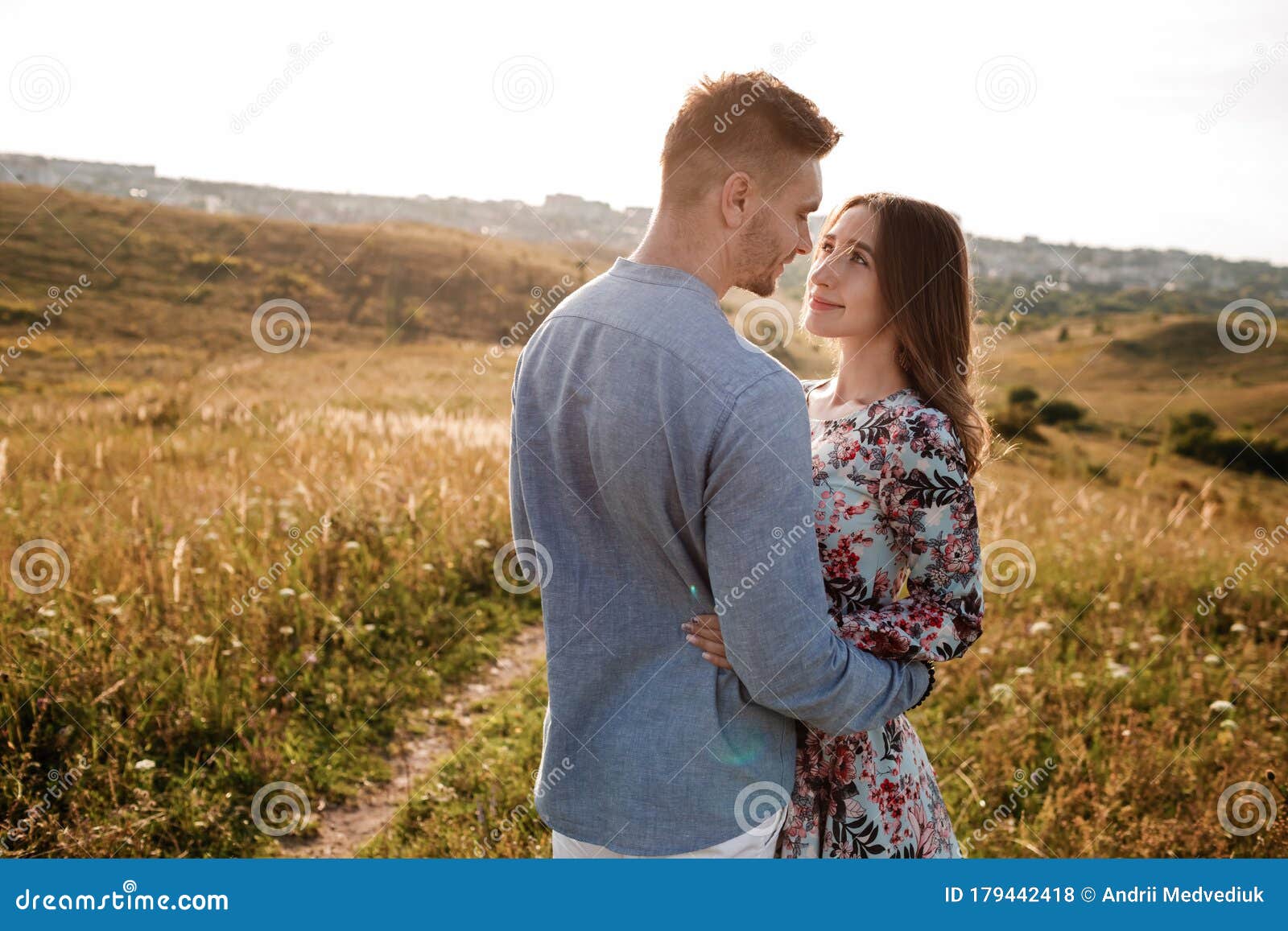 Hugging Couple Smiling and Looking at Each Other, Side View. the Origin ...