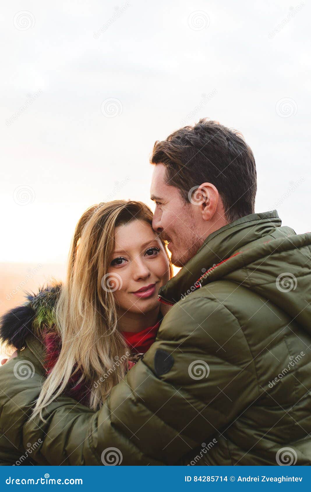 Hugging Couple at Sunset stock photo. Image of light - 84285714
