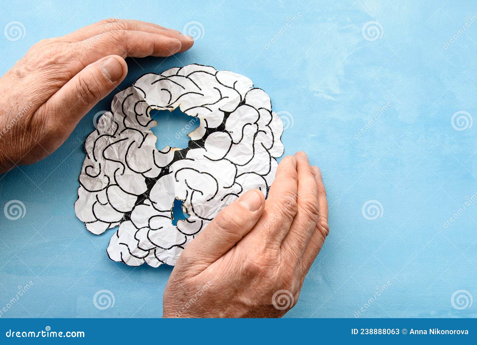Human Brain Made of Paper on a Blue Background a Thrifty Hand Protects ...