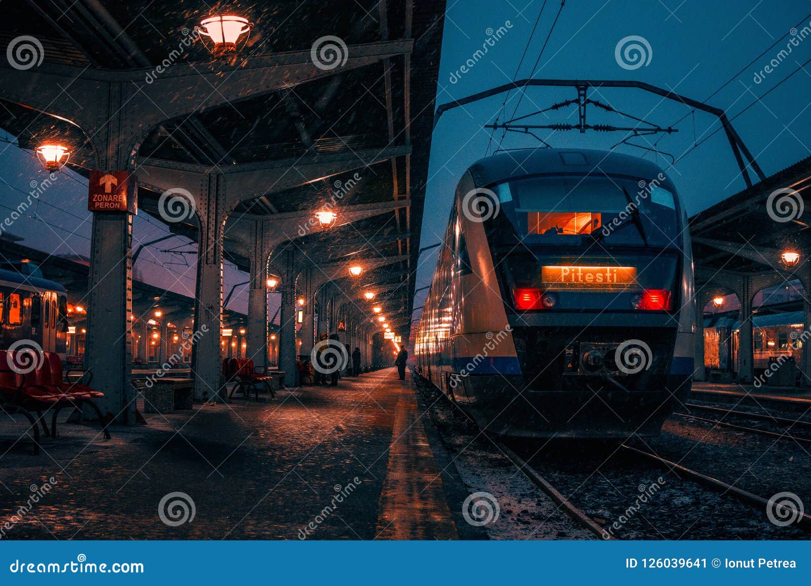 Human in the Dark on a Train Station on the Platform during a Sn ...