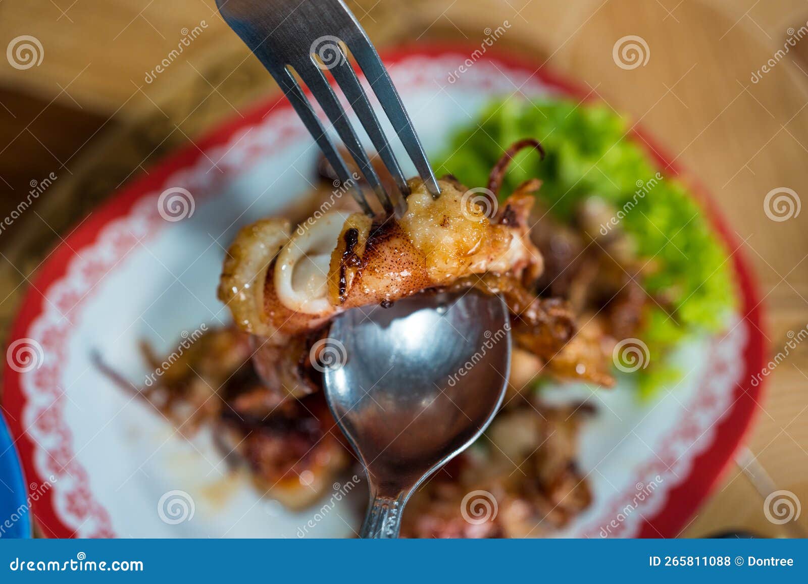 Human Eating Deep Fried Squid with Garlic by Spoon and Fork Stock Photo ...