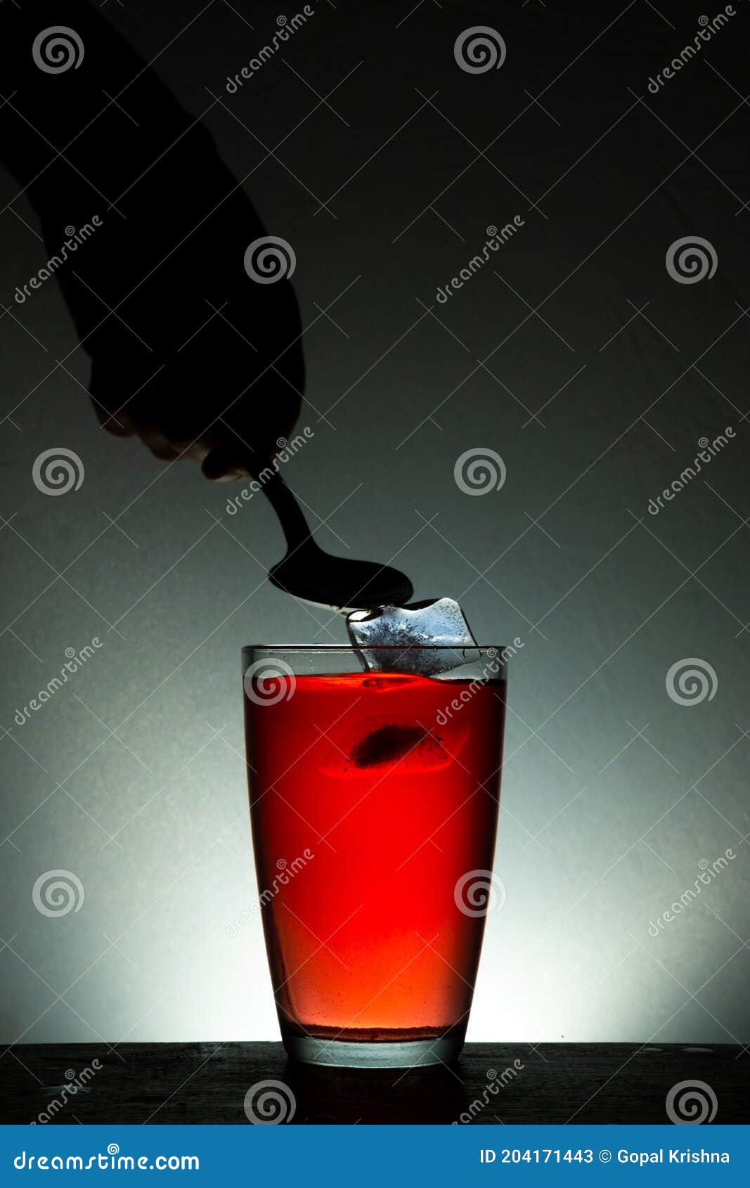 Human Hand Dropping Ice Cube into a Glass of Juice Stock Image - Image ...