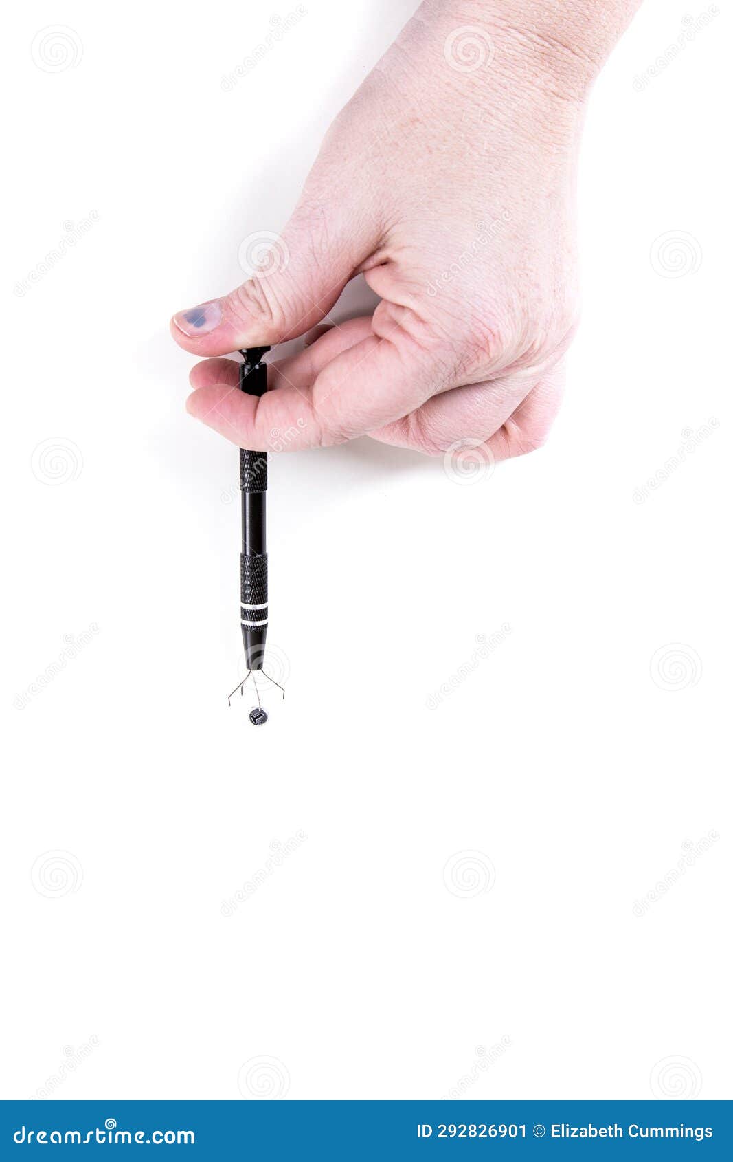 Human Hand Grasping a Bead with a Wire Grabber Tool Stock Image - Image ...